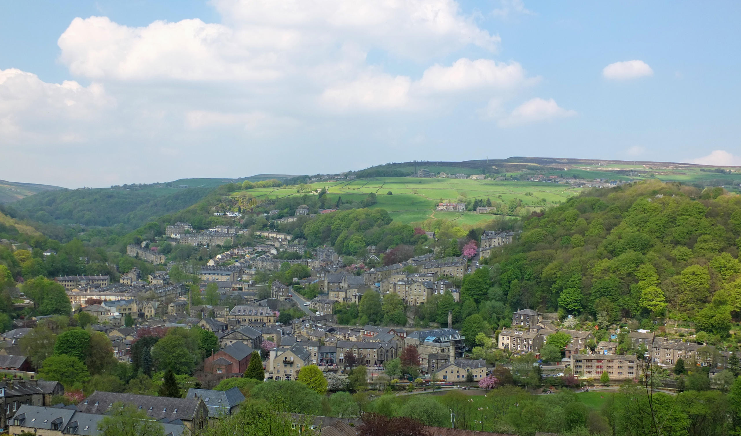 A wide aerial panoramic view of the town of Hebden Bridge with ...